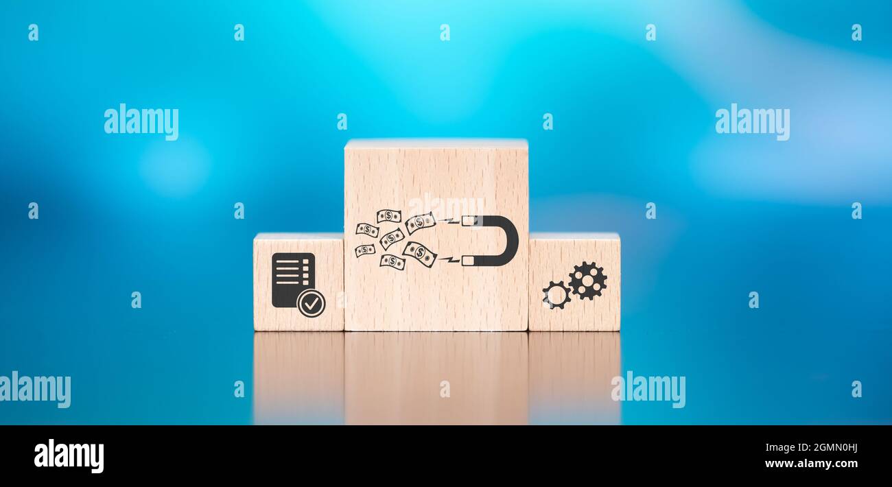 Wooden blocks with symbol of investors attraction concept on blue ...
