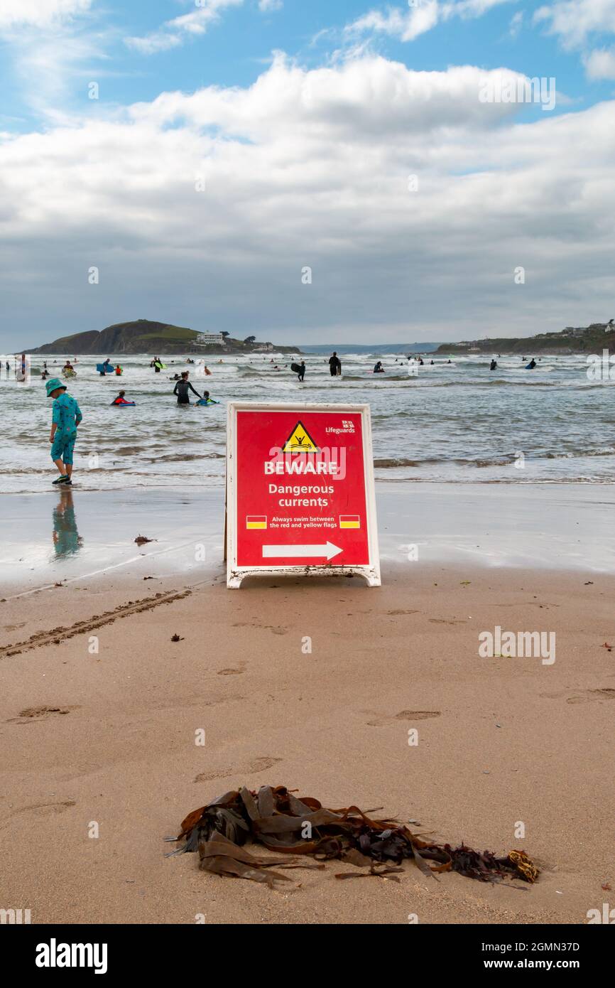 On Bantham Beach, Devon, a RNLI sign warns swimmers of dangerous ...