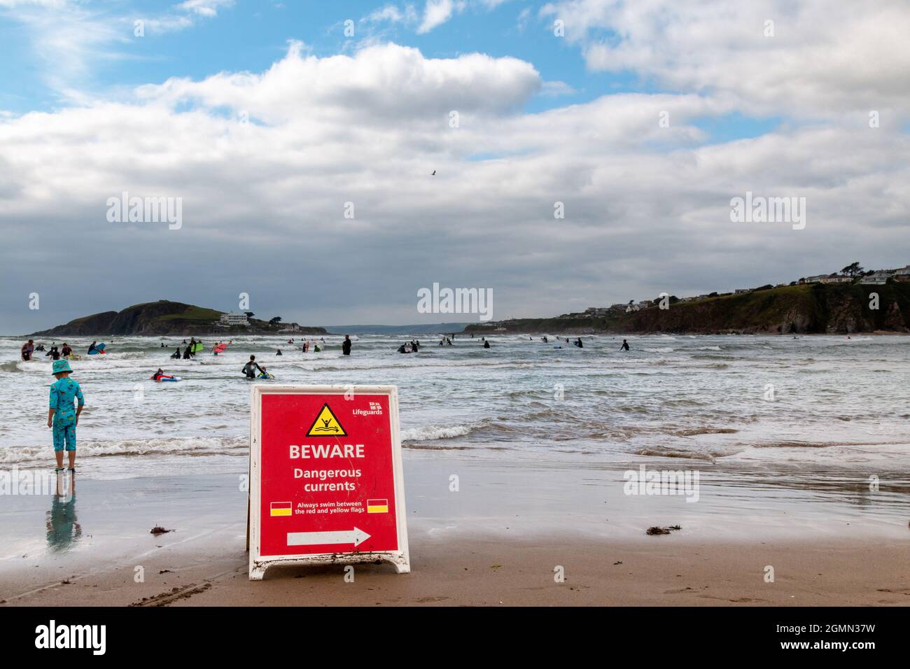 On Bantham Beach, Devon, a RNLI sign warns swimmers of dangerous ...