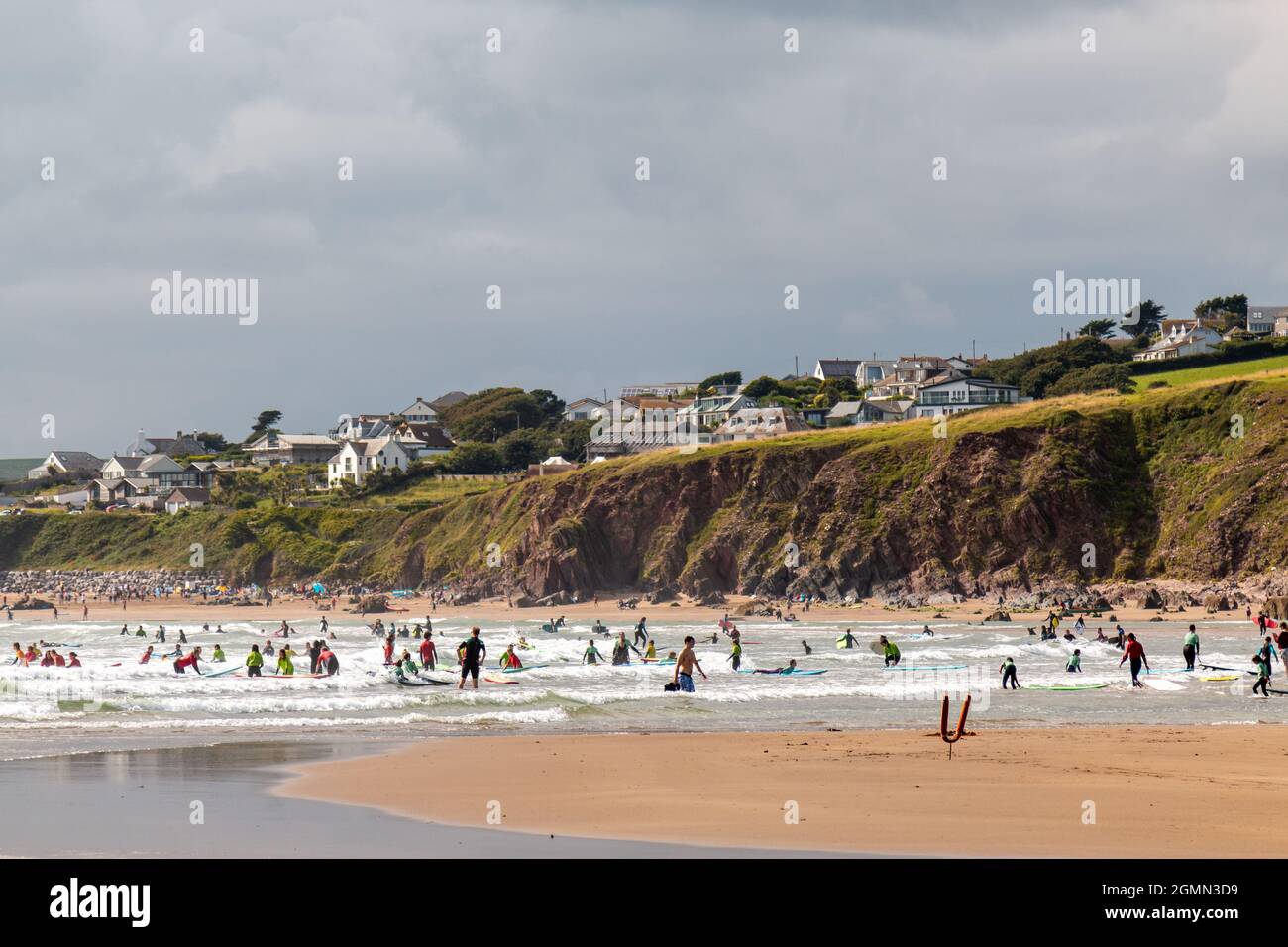Bantham Beach, Devon, on a sunny summer day. The sea is busy with lots ...