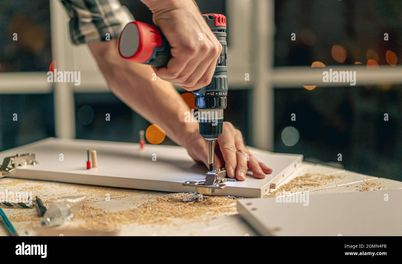 Man working during process of furniture manufacturing Stock Photo - Alamy
