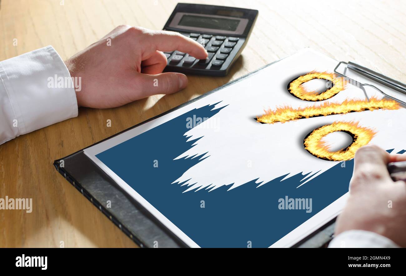 Interest rates concept with hand using a calculator Stock Photo - Alamy