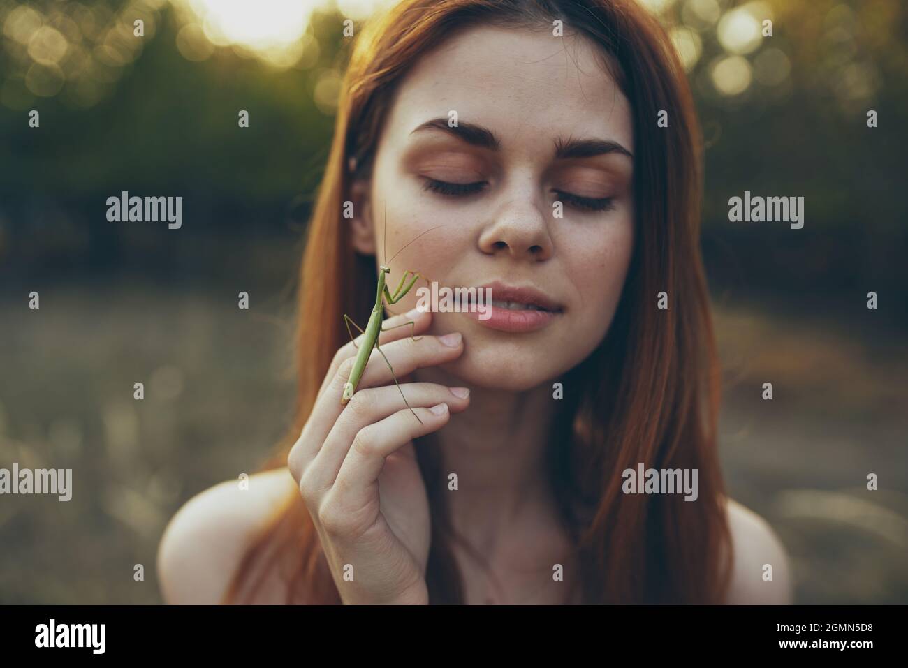 woman in white dress with a praying mantis in hand close-up Stock Photo ...