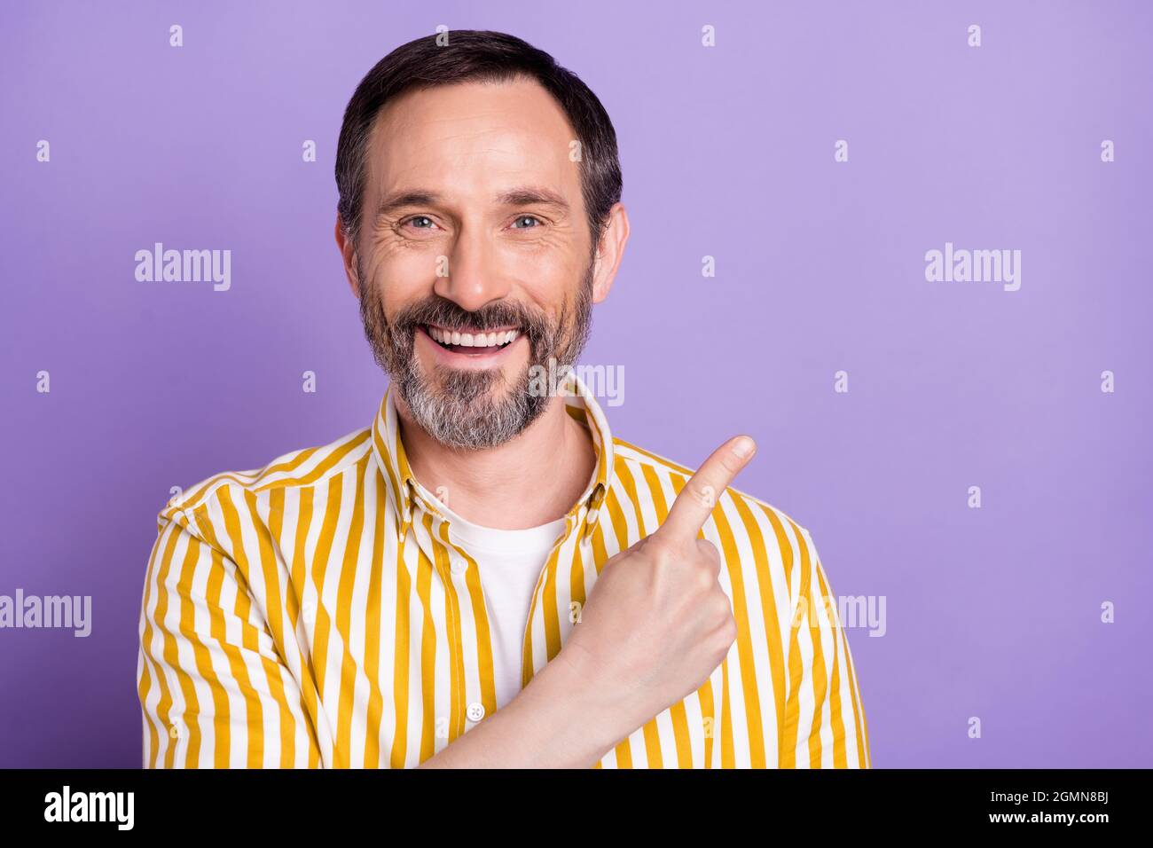 Photo of excited sweet mature man dressed striped shirt pointing finger ...