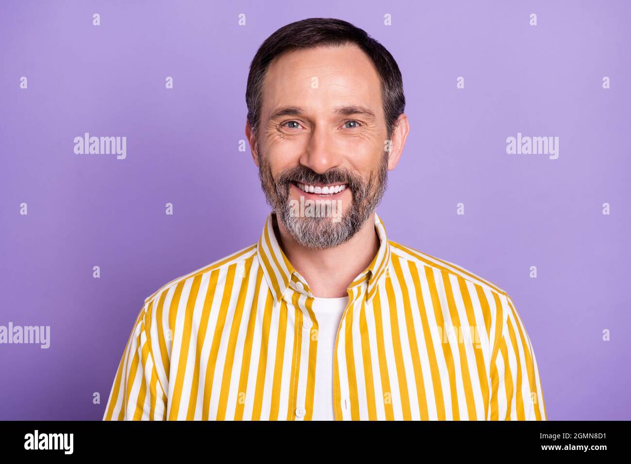 Photo of pretty positive mature man dressed striped shirt smiling ...