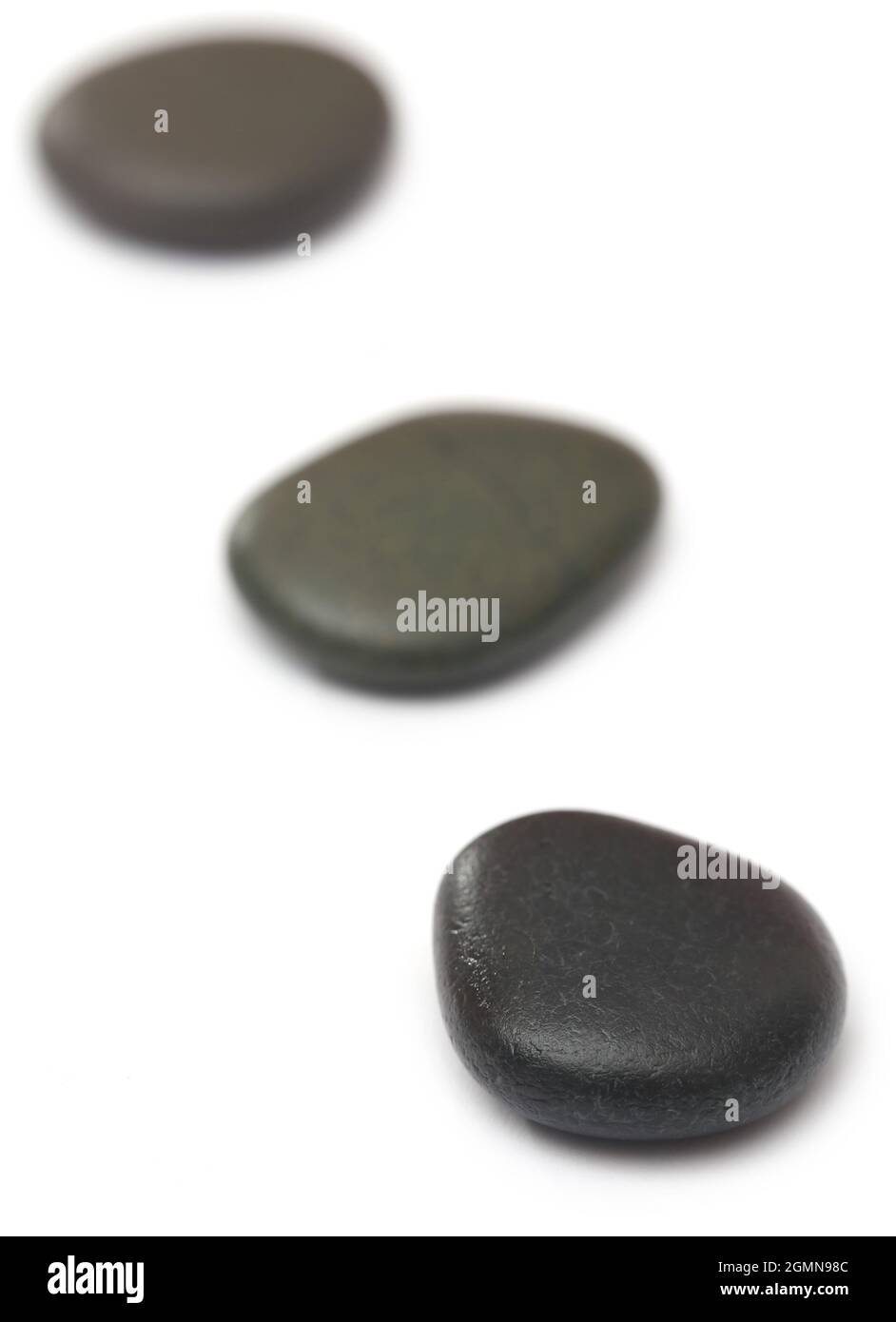 Massage stone isolated over white background Stock Photo - Alamy
