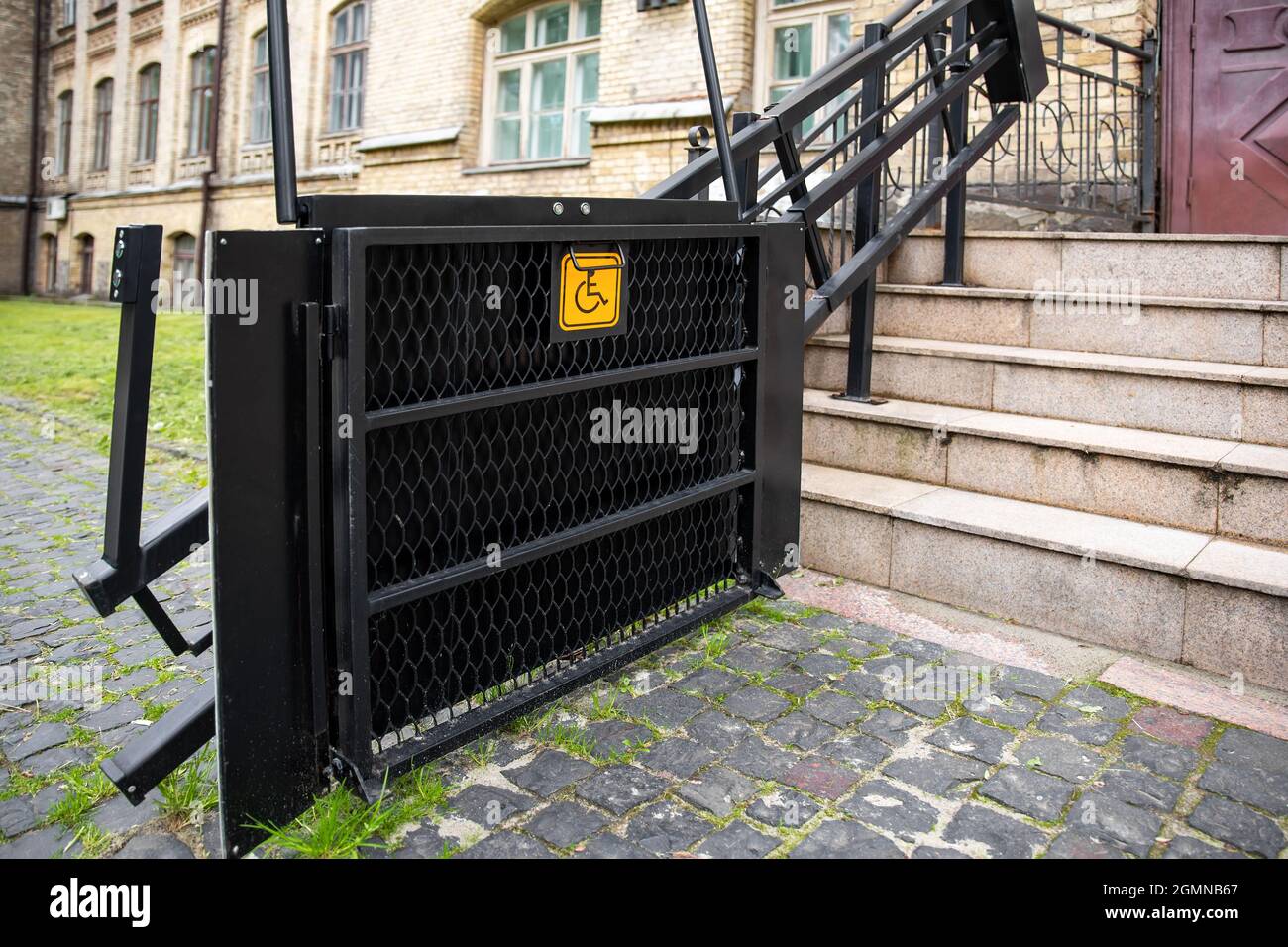Electric platform lift at building staircase for disabled people with ...