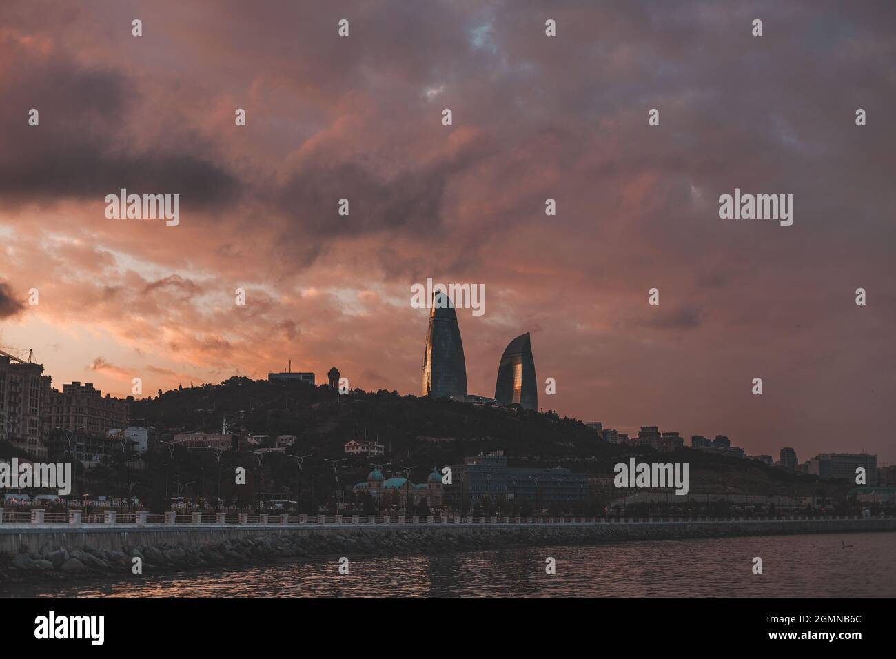 Embankment of Baku at sunset. View from the river to the embankment ...