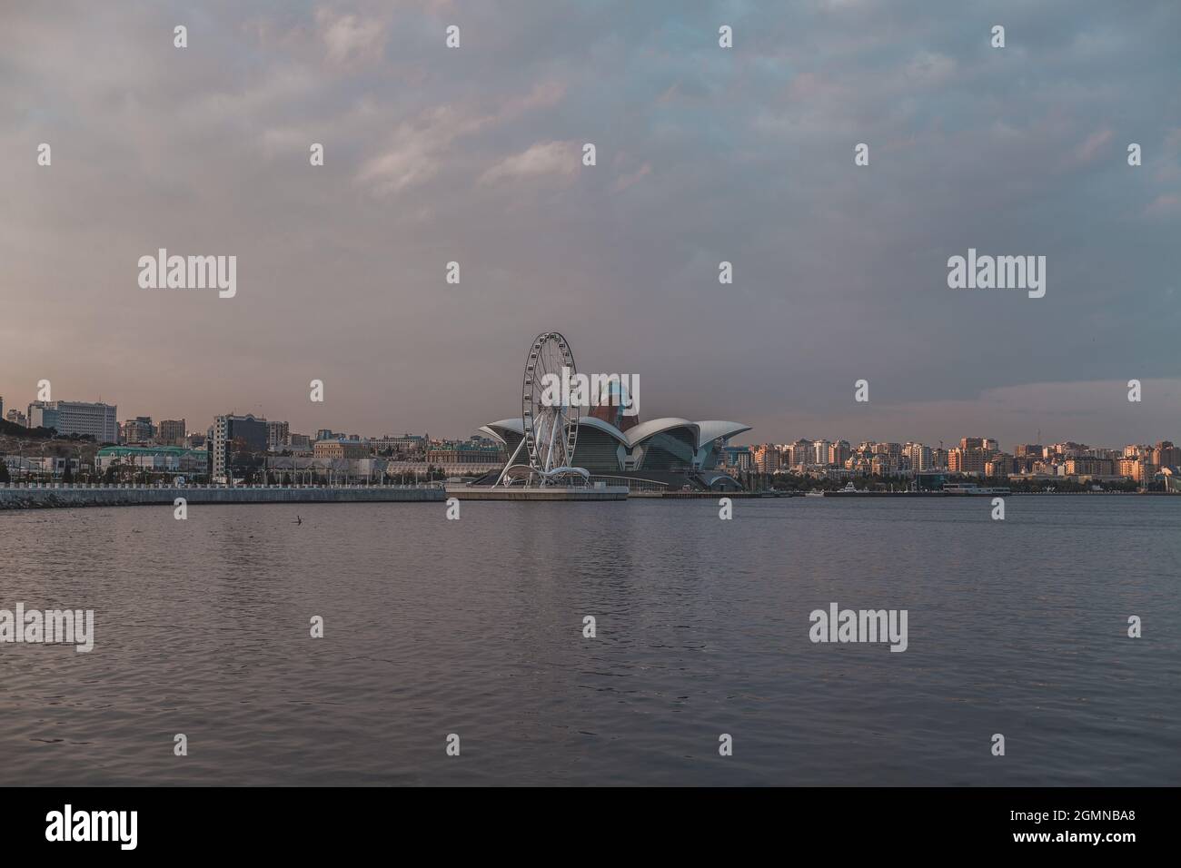 Embankment of Baku at sunset with modern buildings. Cloudy sunset sky ...