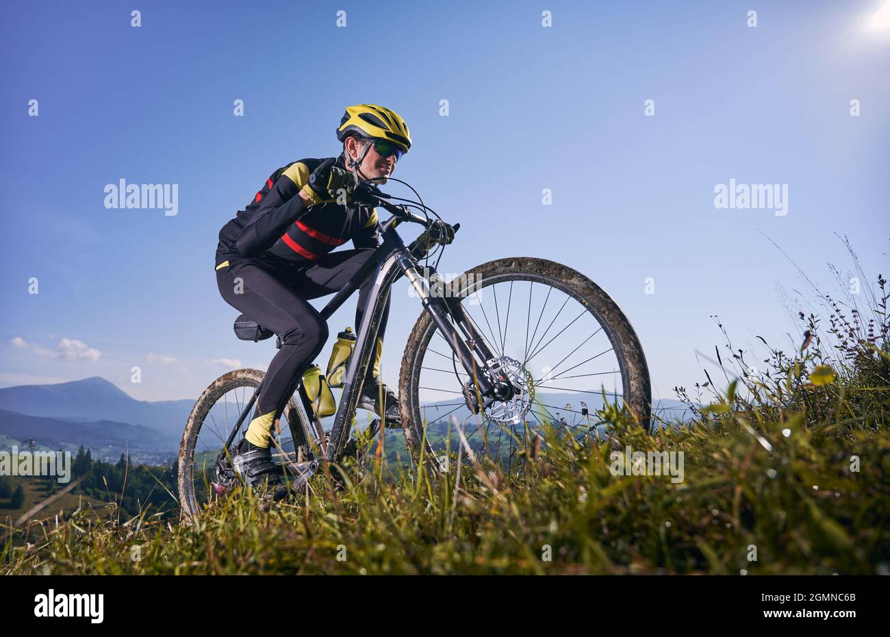 Person riding bike uphill hi-res stock photography and images - Alamy