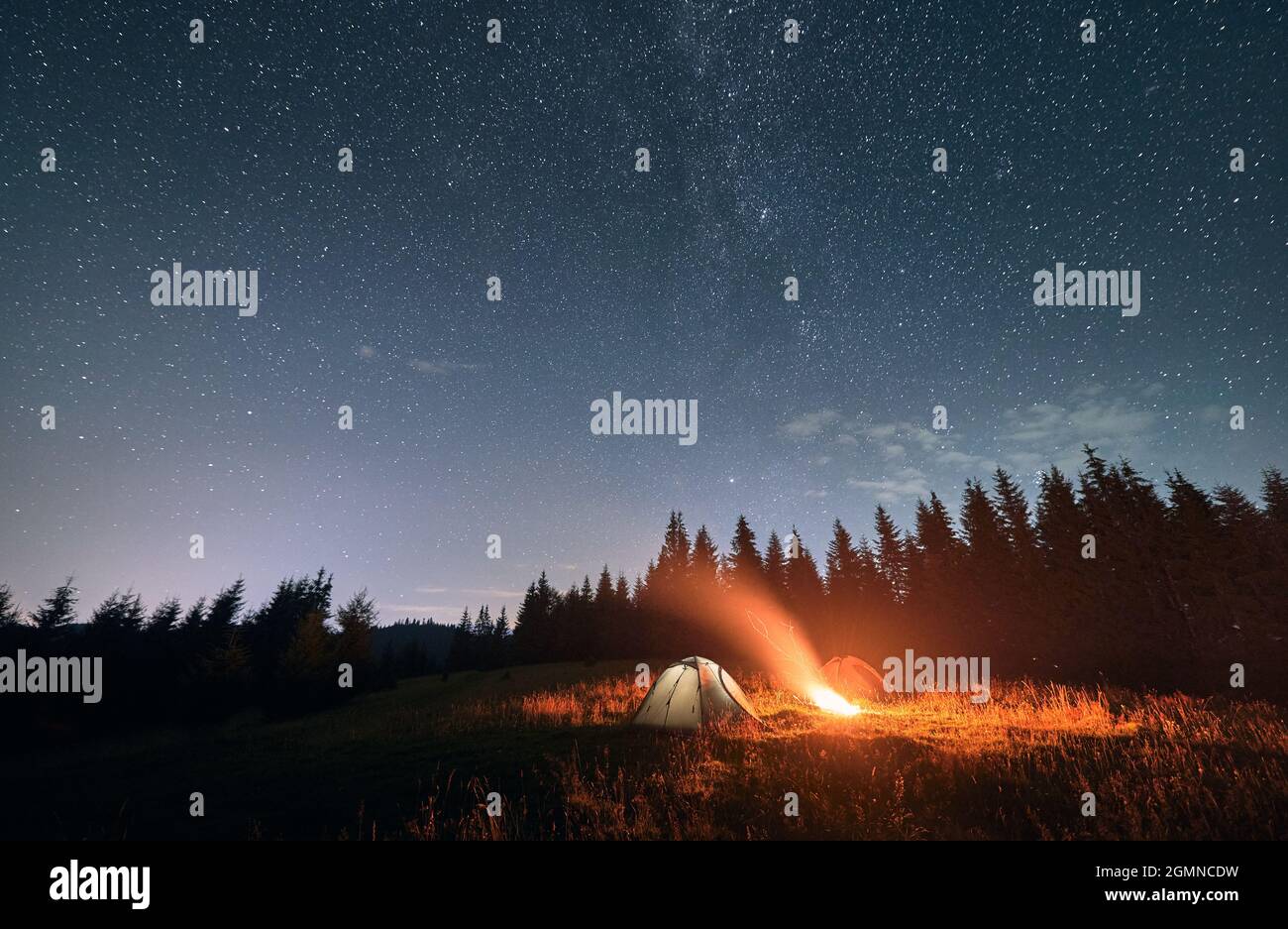 Night camping under amazing starry sky. Wide angle view on beautiful ...