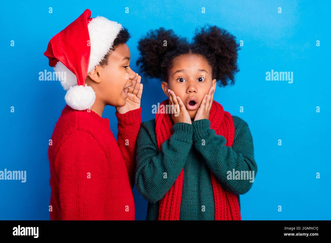 Photo of funky shocked dark skin children wear pullovers arms cheeks ...