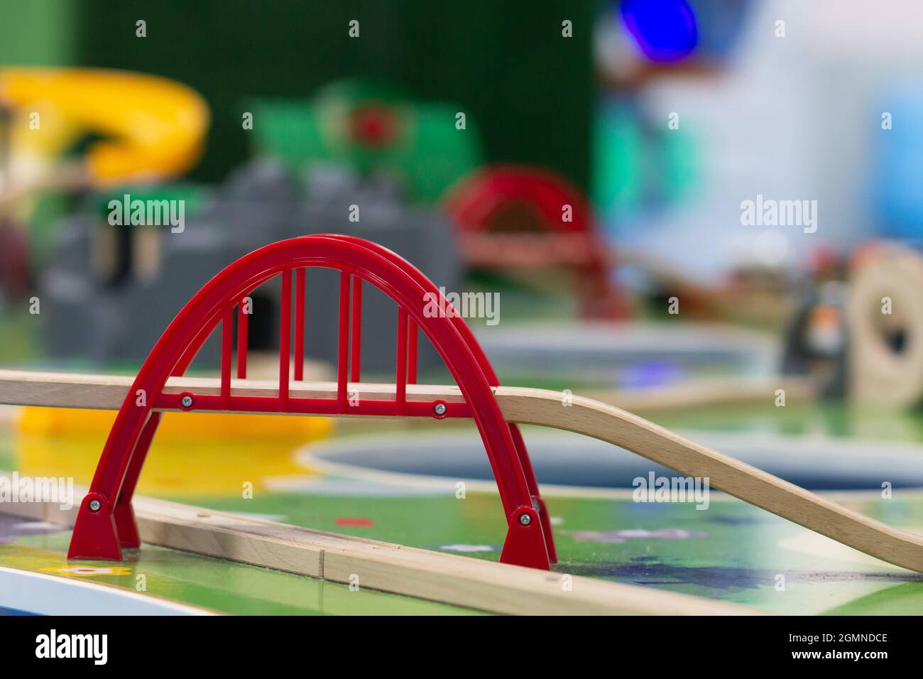 Toy red bridge on playground for train inside Stock Photo - Alamy