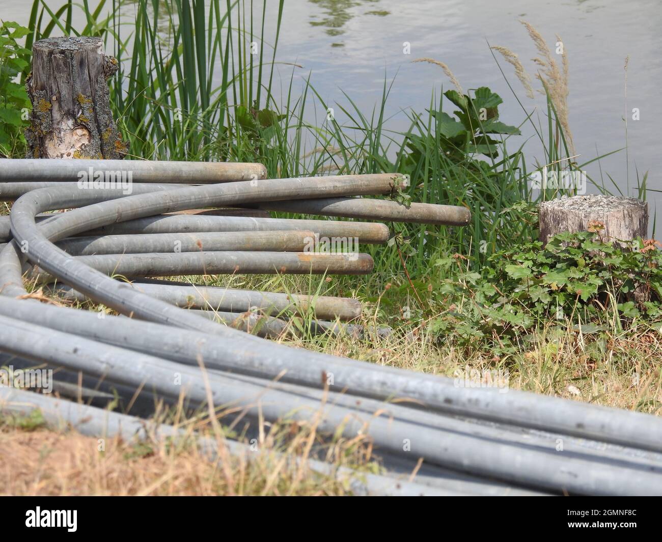 Lake and the pipes on the coast Stock Photo - Alamy
