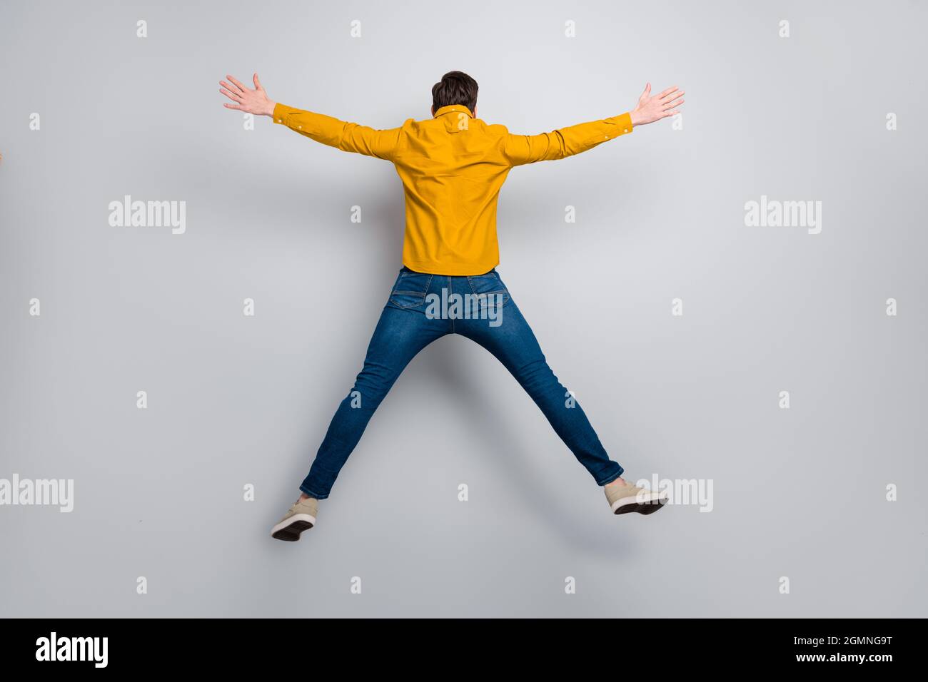 Full length body size rear back behind view of attractive free man ...