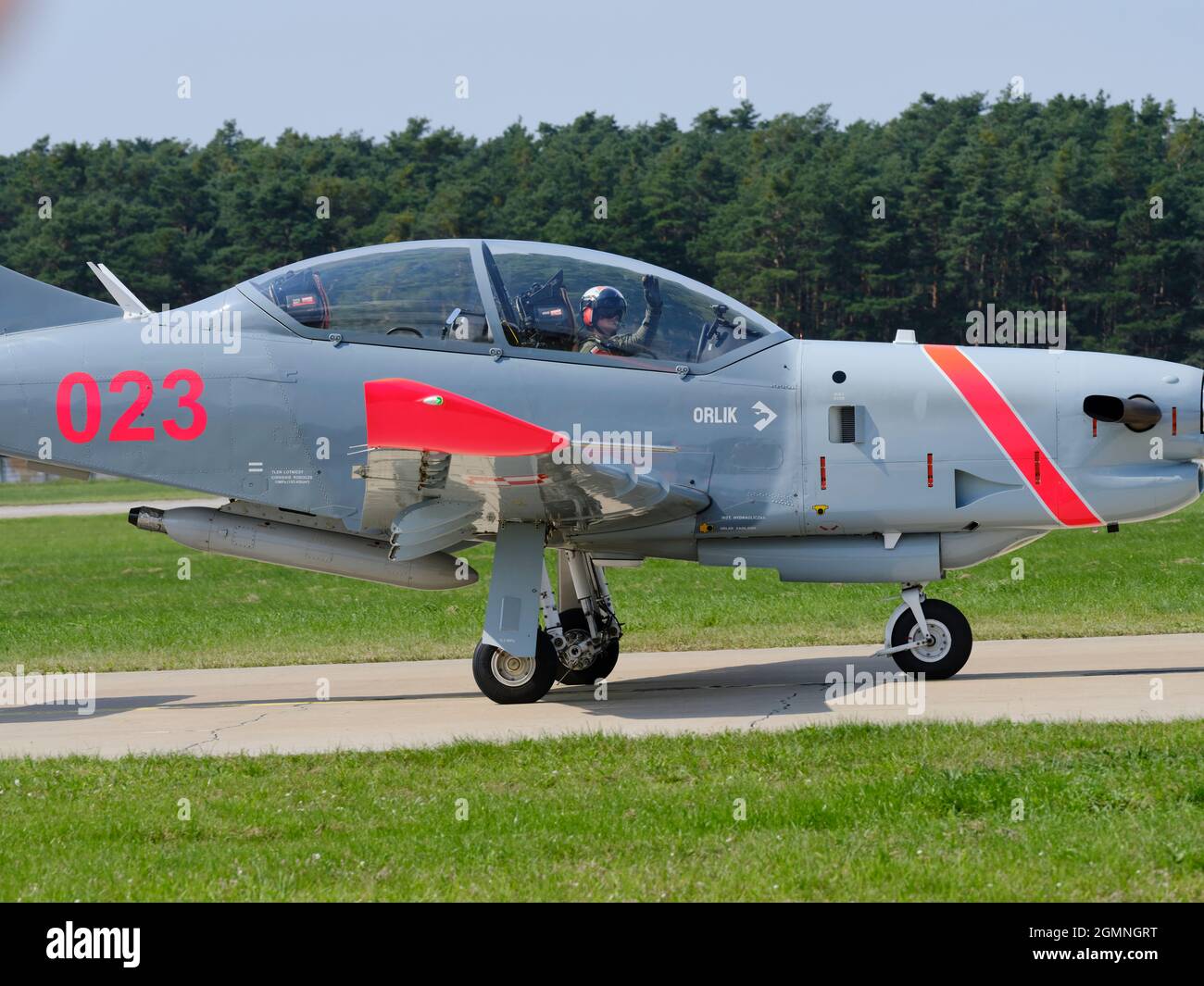 The pilot of a historic fighter waving from the cockpit before takeoff ...