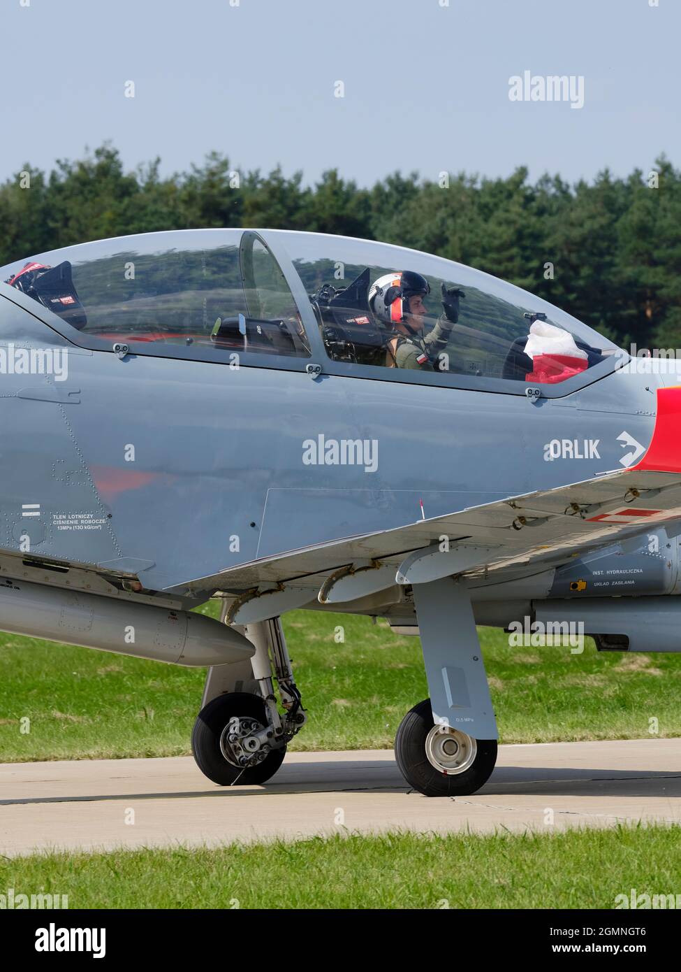 The pilot of a historic fighter waving from the cockpit before takeoff ...