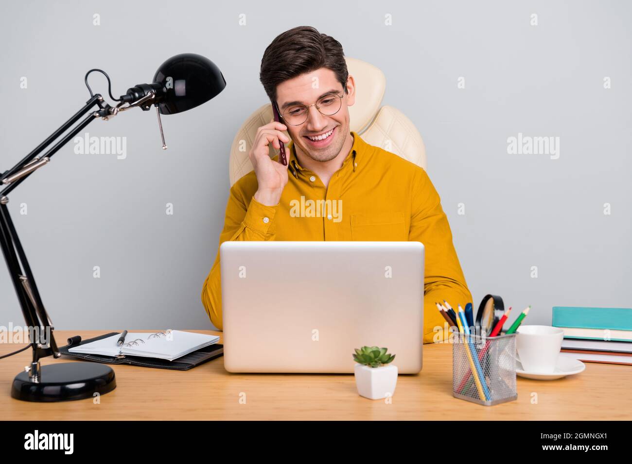 Portrait of attractive cheerful man using gadget calling contact ...