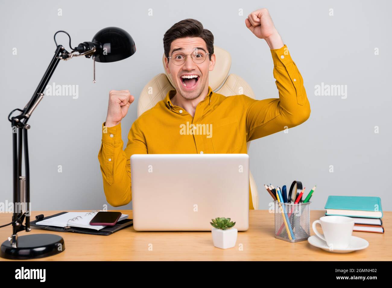 Portrait of attractive cheerful man programmer having fun rejoicing ...
