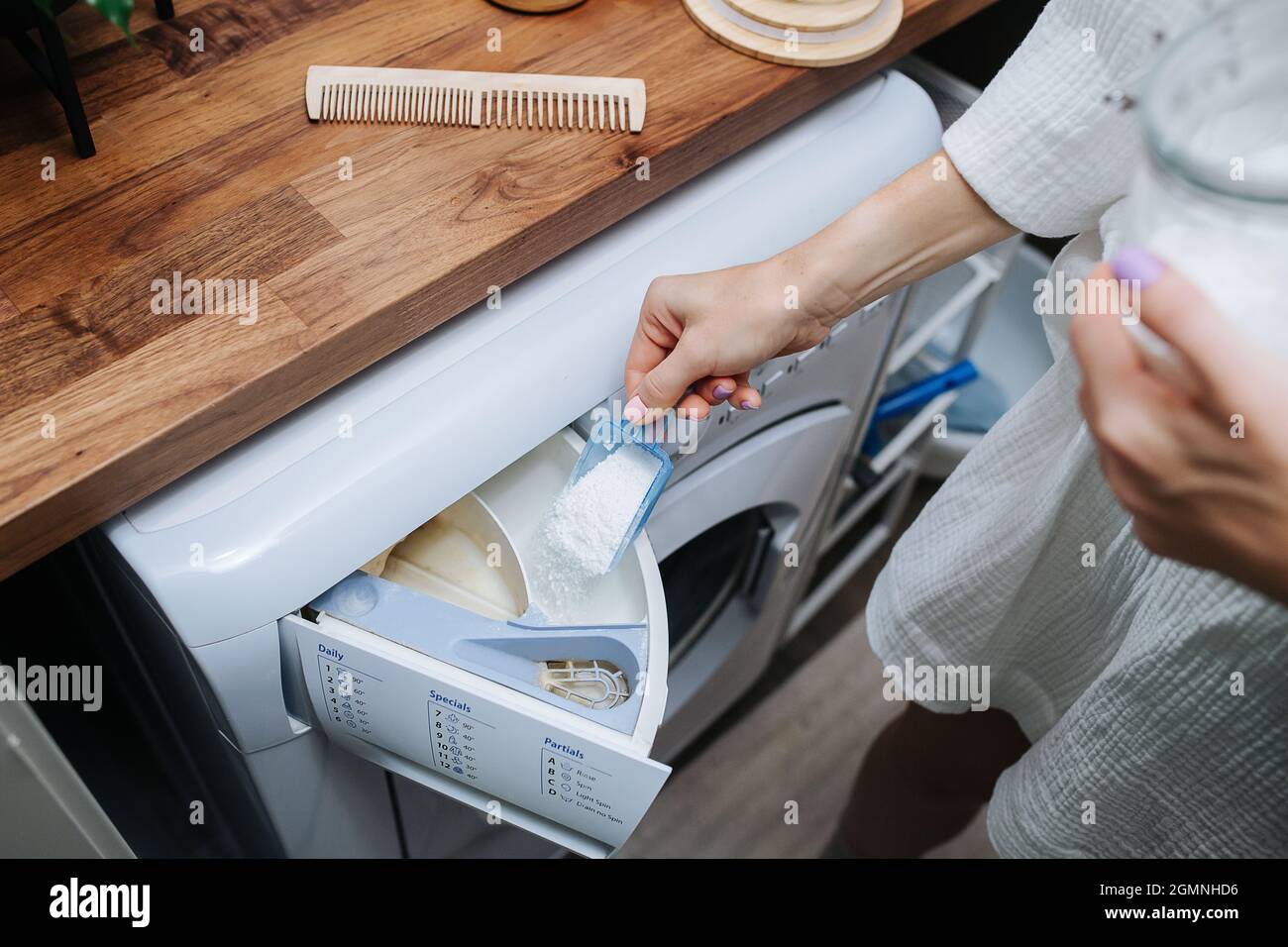 No head image of a woman pouring powder in a washer. High angle Stock ...