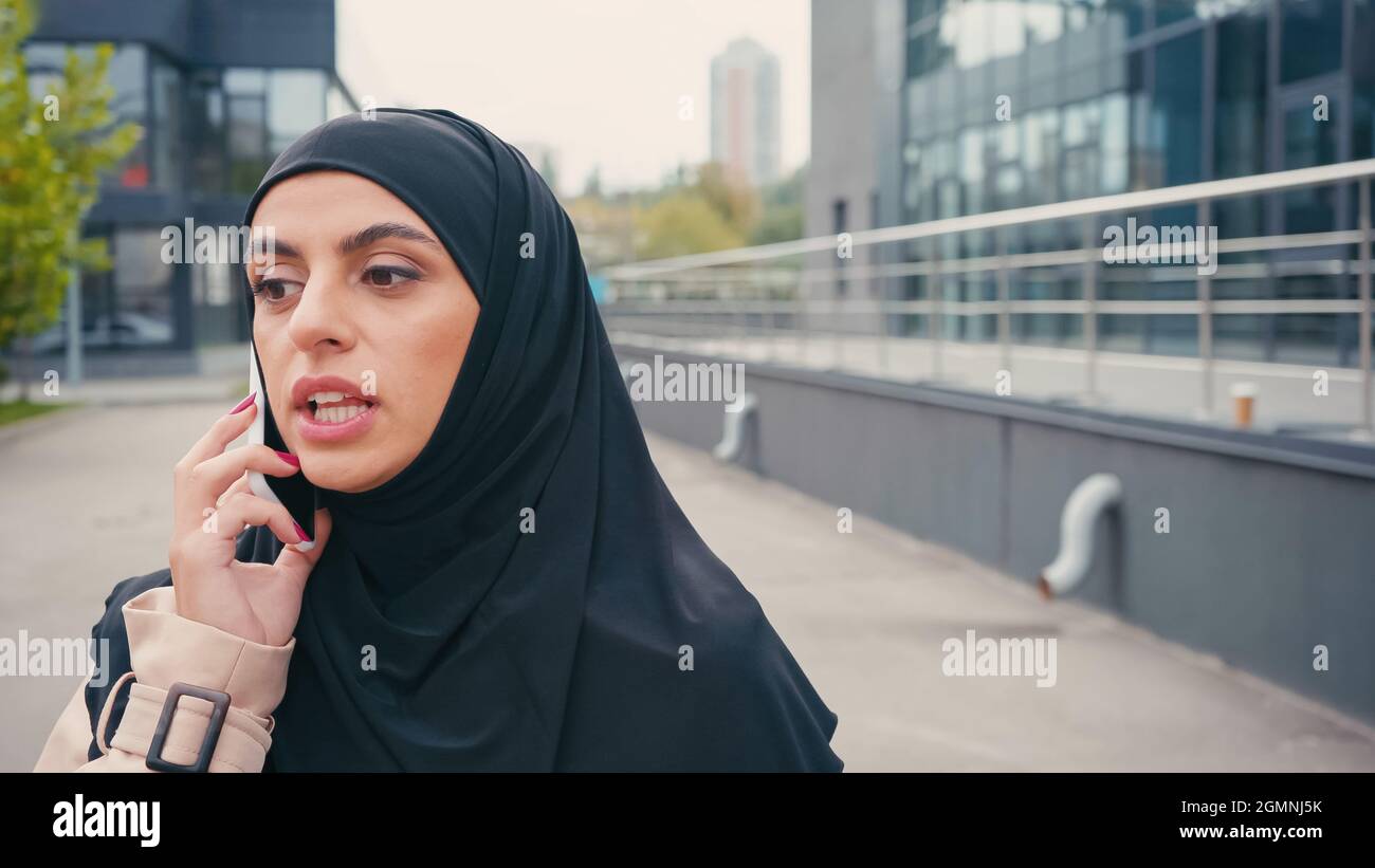 muslim woman in hijab talking on smartphone outside Stock Photo - Alamy