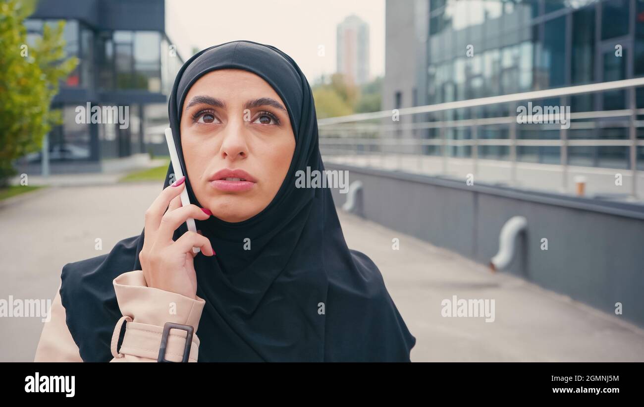 Young muslim woman in hijab having phone call outside Stock Photo - Alamy
