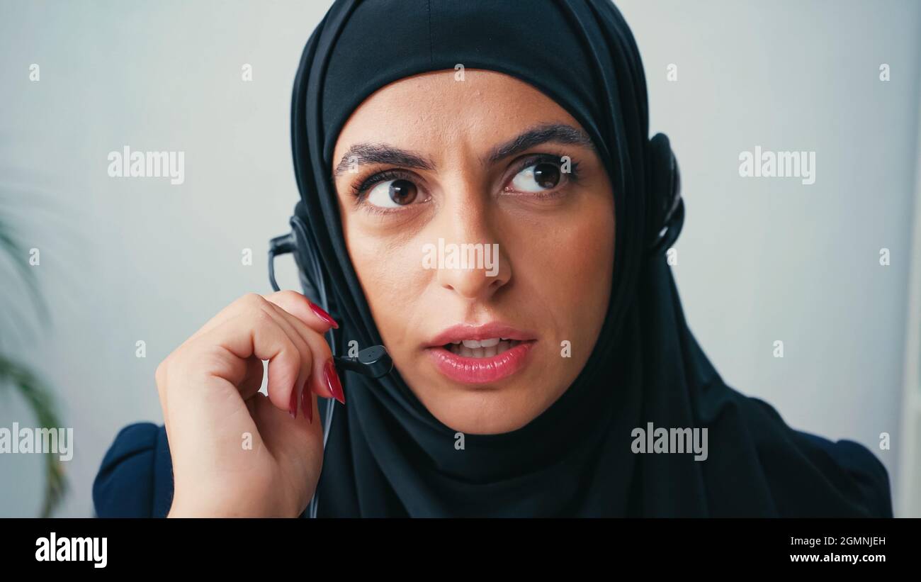 Muslim operator of call center using headset in office Stock Photo - Alamy