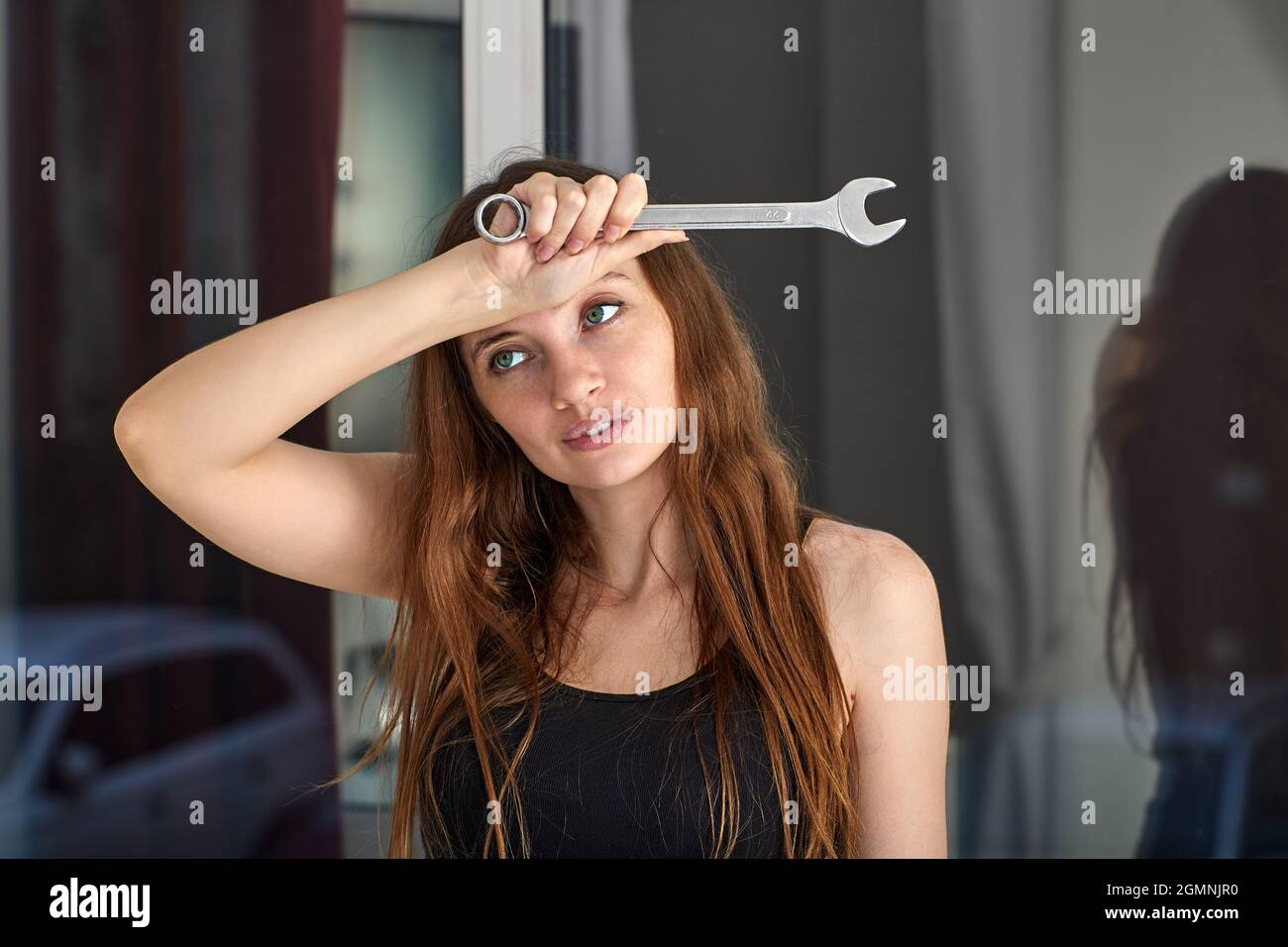 Tired woman repairs plumbing on her own at home Stock Photo - Alamy
