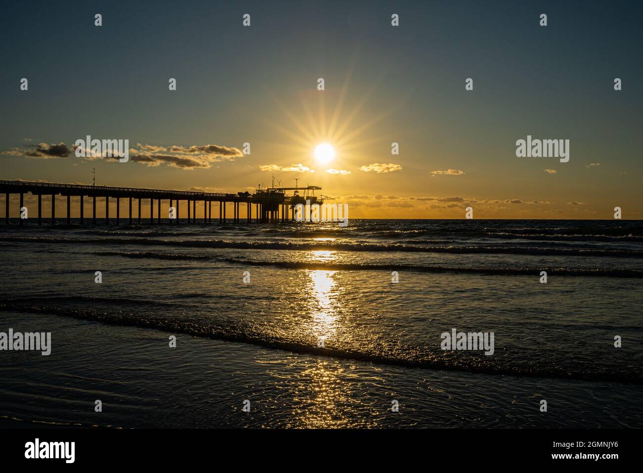 Silhouette of a construction platform on the beach on the sunset Stock ...