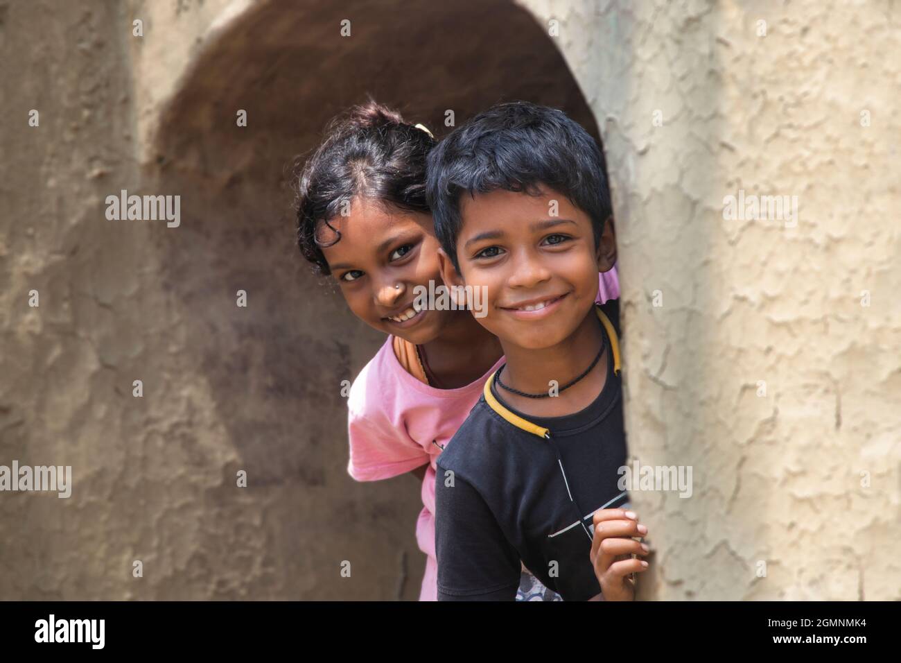 Indian rural Kids Peeking from Earthen wall Stock Photo - Alamy