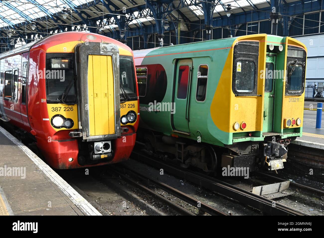 Two passenger trains inside Brighton station Stock Photo - Alamy