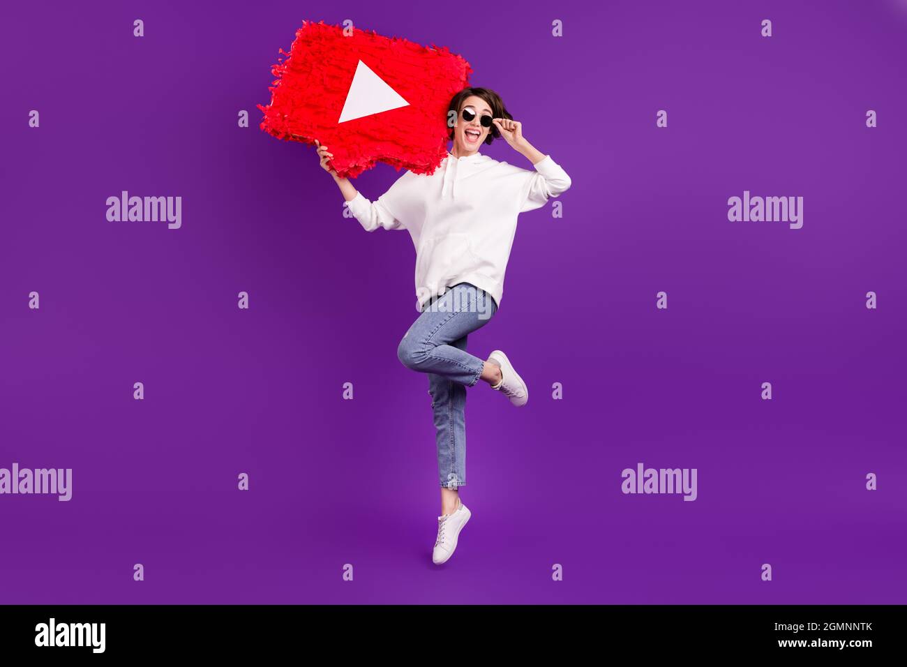 Full size photo of young good mood positive girl jumping with big red ...