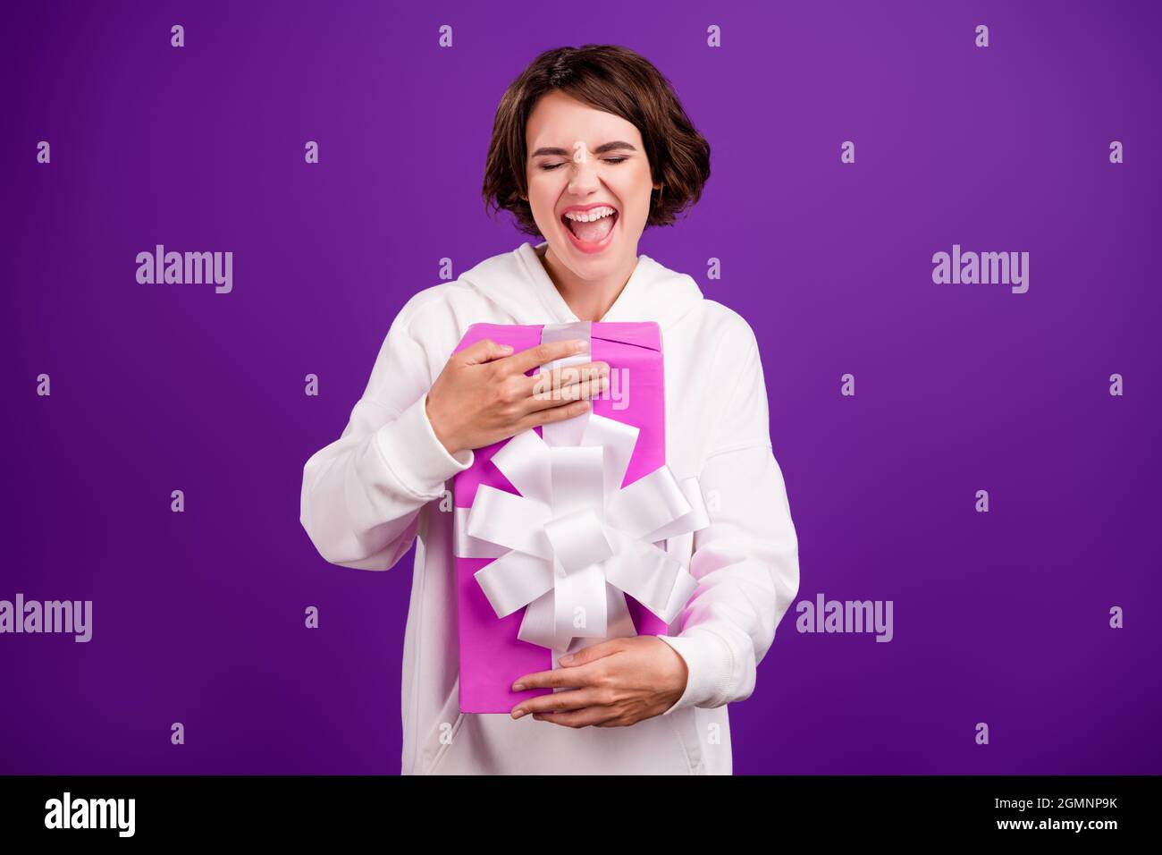 Photo of good mood positive screaming girl hug embrace birthday present ...