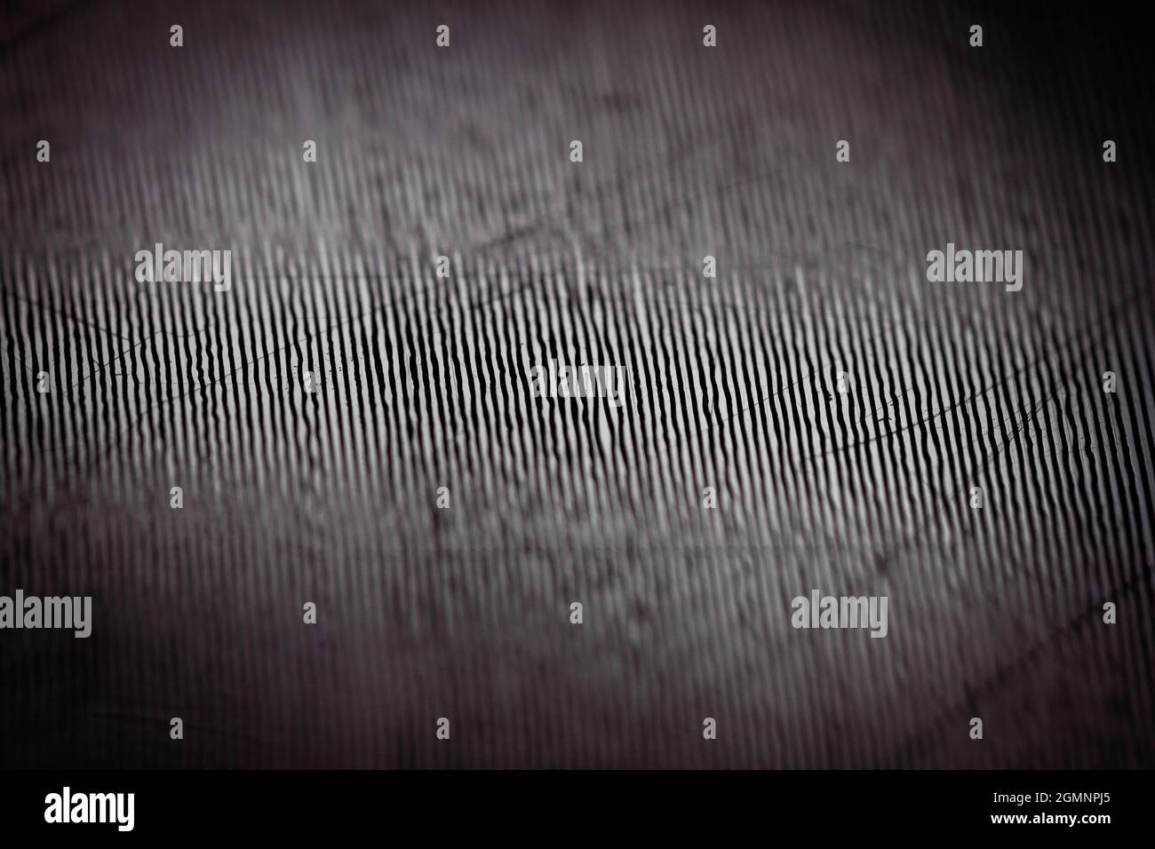 Macro shot of black vinyl record showing scratches. Surface of an old ...