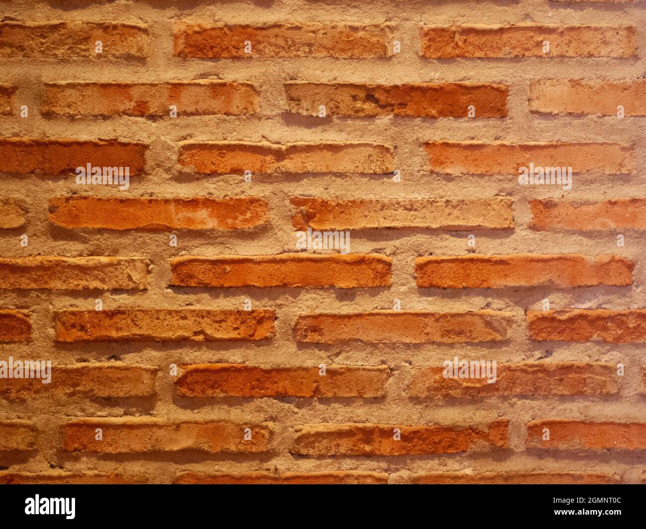 Rustic red orange brick wall with cement for background and space for ...