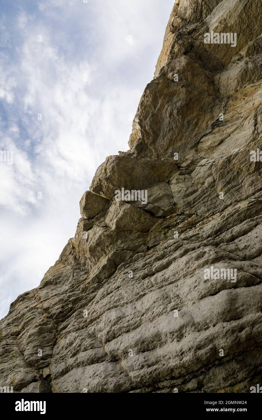 Steep rocky mountain slope. Layers of rocks. Blue sky with cirrus ...