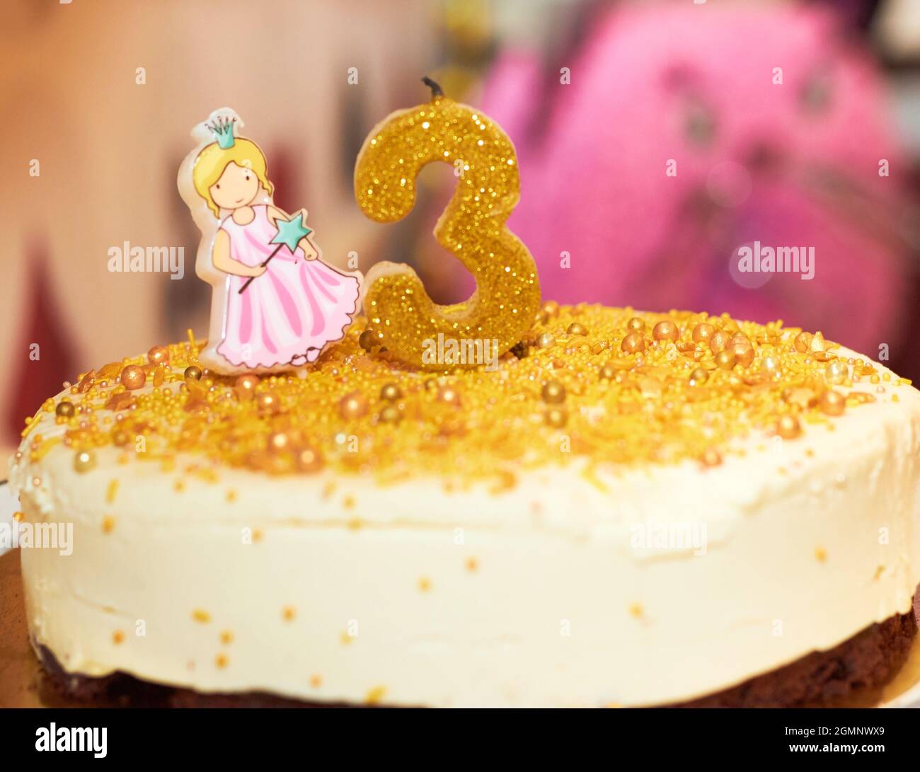 Third birthday of girl. Pink number 3 on birthday cake with princess ...