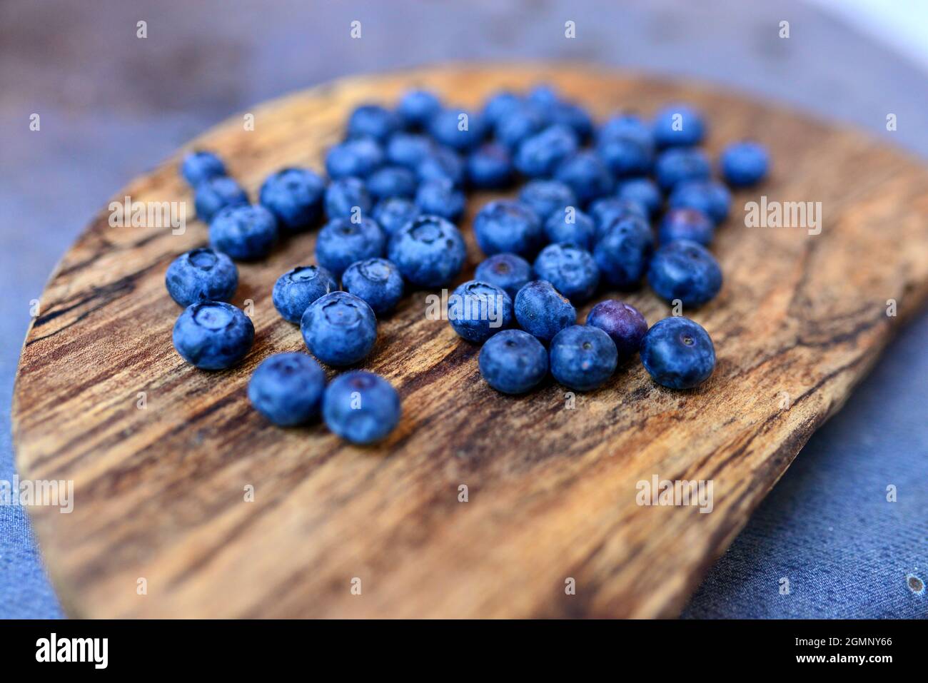Blueberries on wooden kitchen board Stock Photo - Alamy
