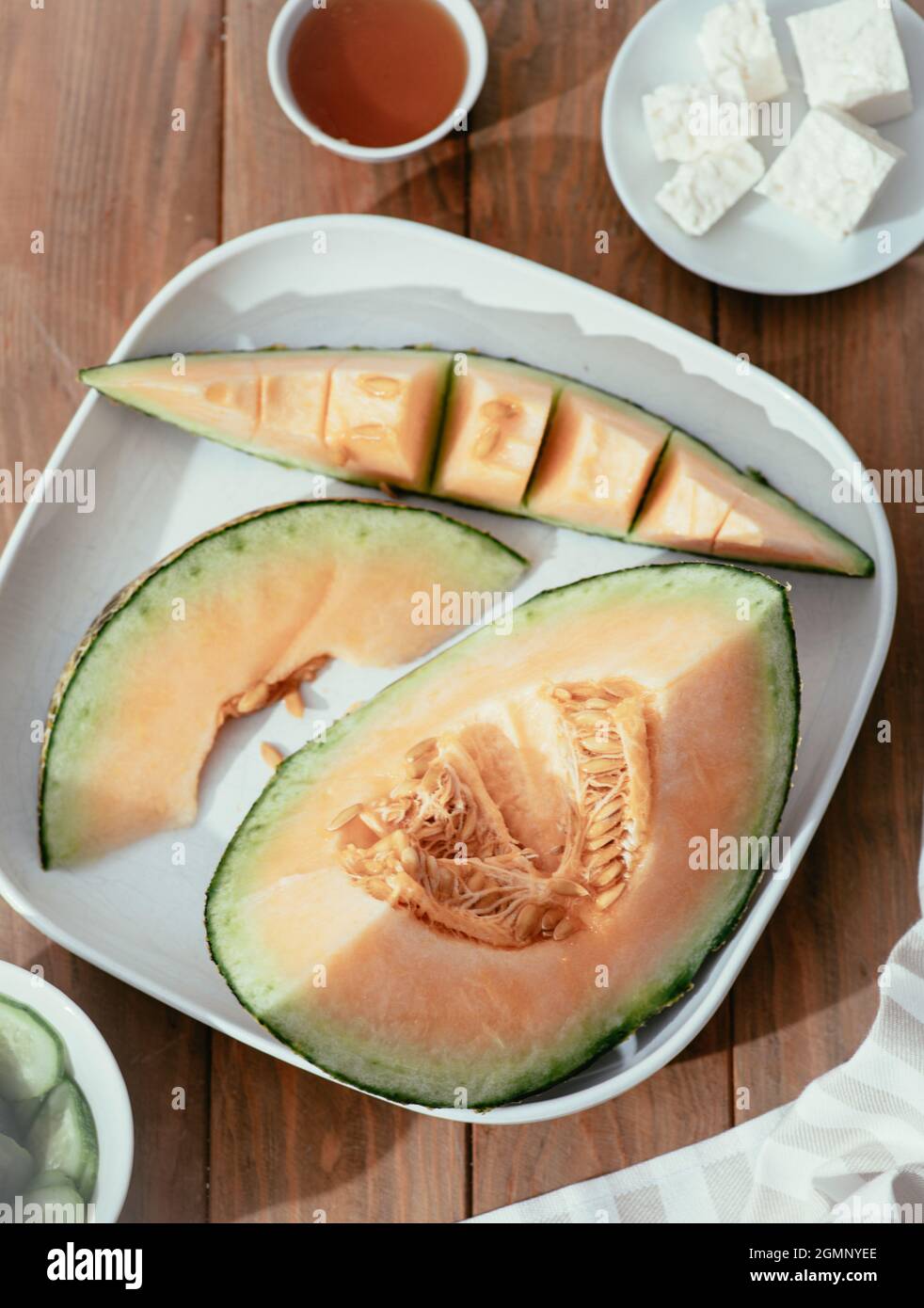 Fresh melons sliced on wooden table. Free space for text. Top view ...