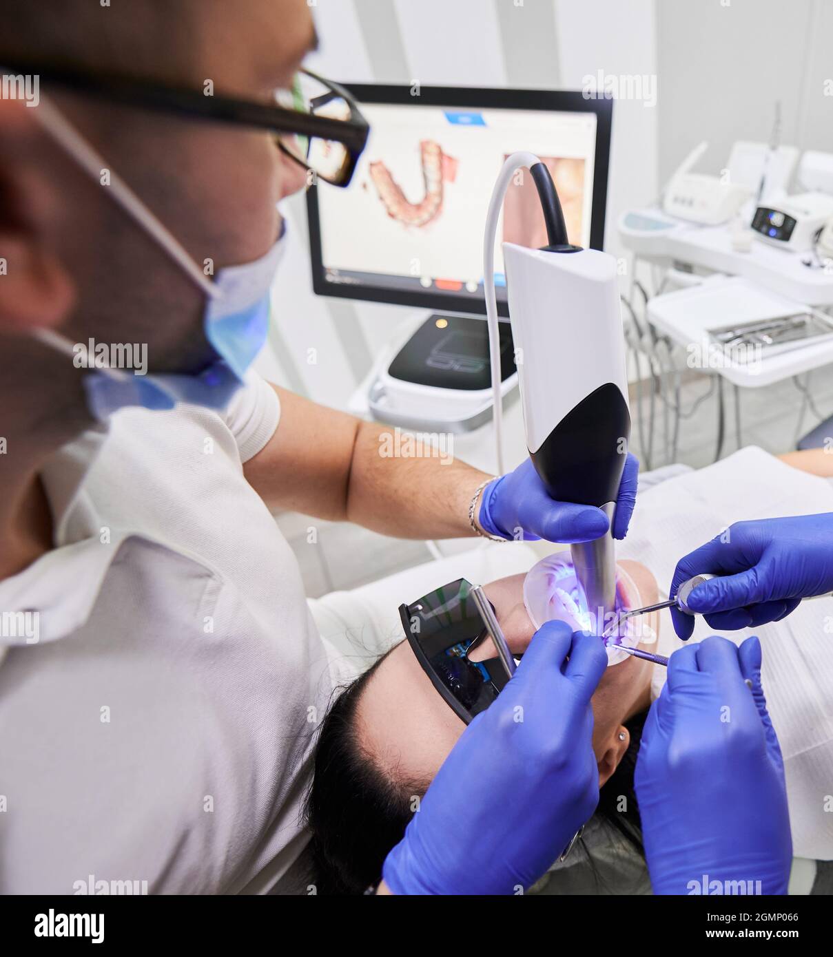Close up of dentist and assistant using dental intraoral scanner while ...