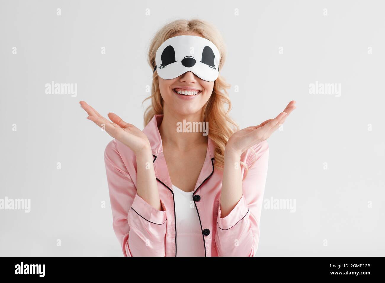 Funny happy millennial european blonde woman in sleep mask, spreads her ...