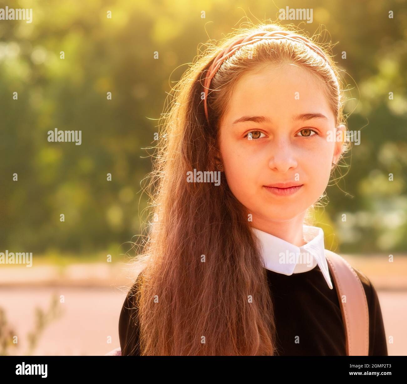 Girl 11 years old. Schoolgirl in school clothes in nature on a ...