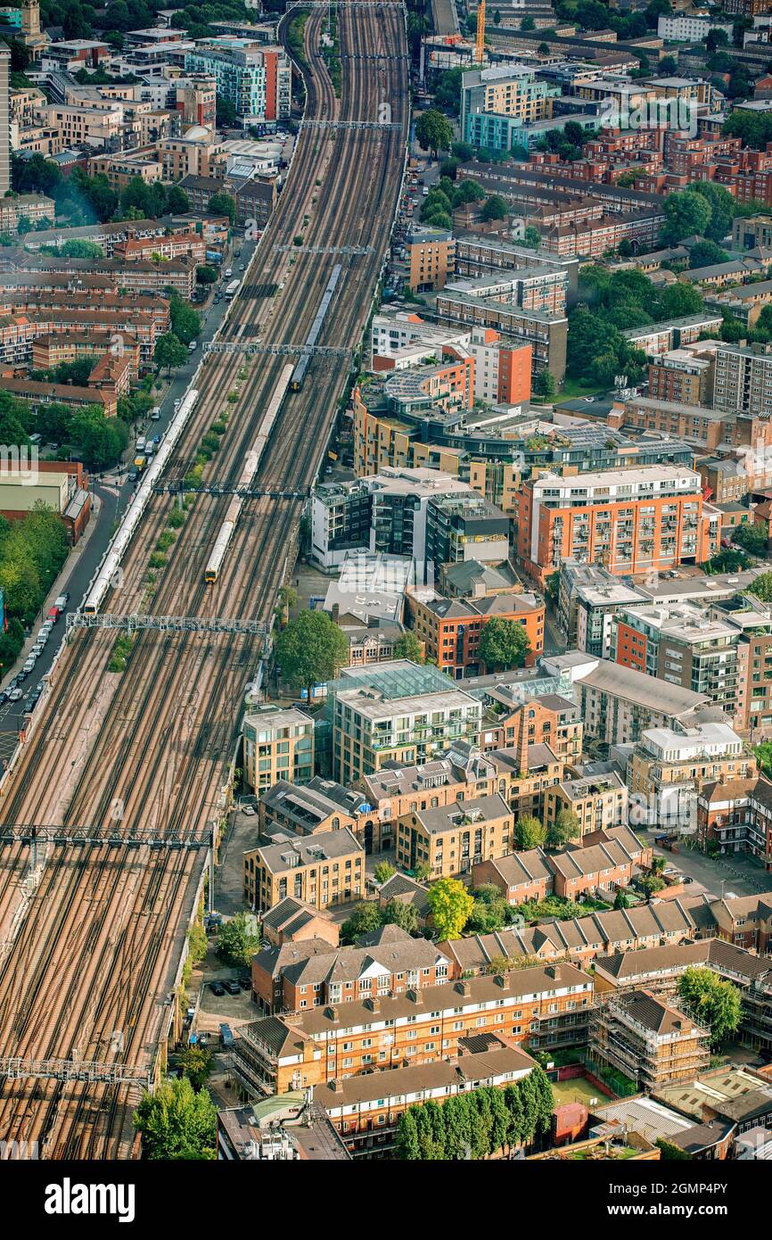 Train on train tracks next to buildings and house in London taken from ...