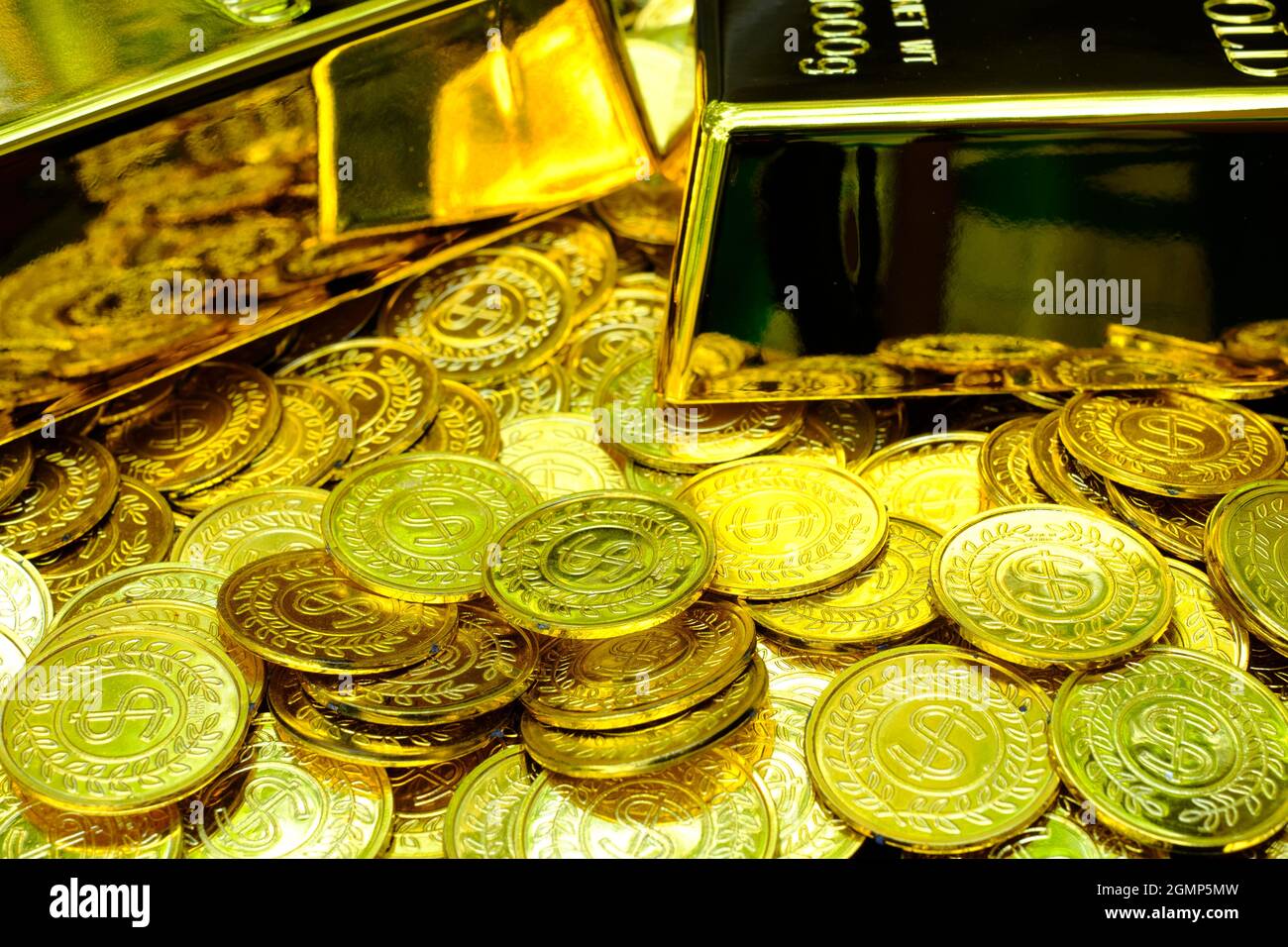 Gold bullion on pile golden coins a lot of Stock Photo - Alamy