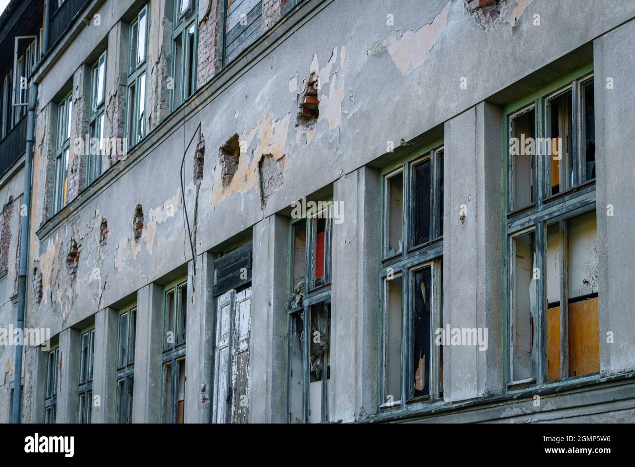 view of an old demolished building and smashed windows with broken ...