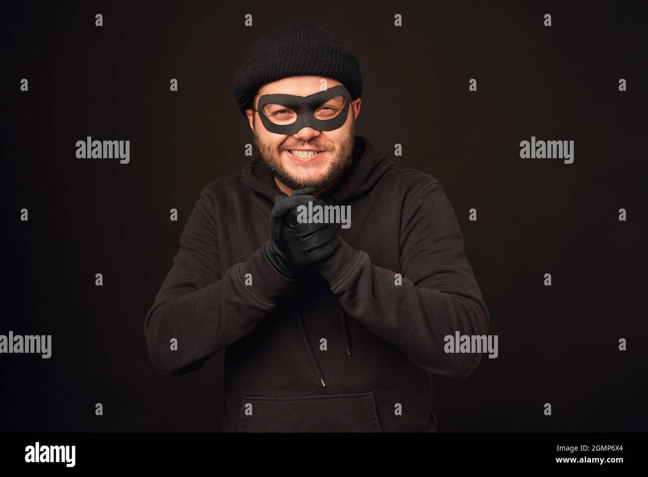 Portrait of funnu thief with mask over dark back Stock Photo - Alamy