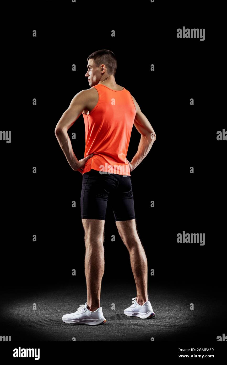 Full-length back view portrait of young male professional athlete ...