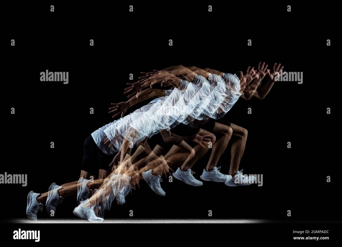 Young male professional athlete running, training isolated over black ...