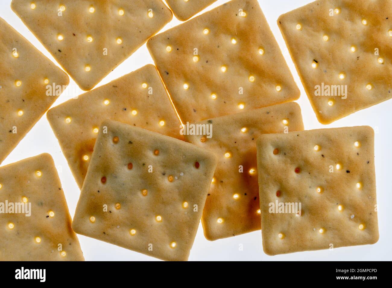 stack of square crackers in backlight isolated on white background ...