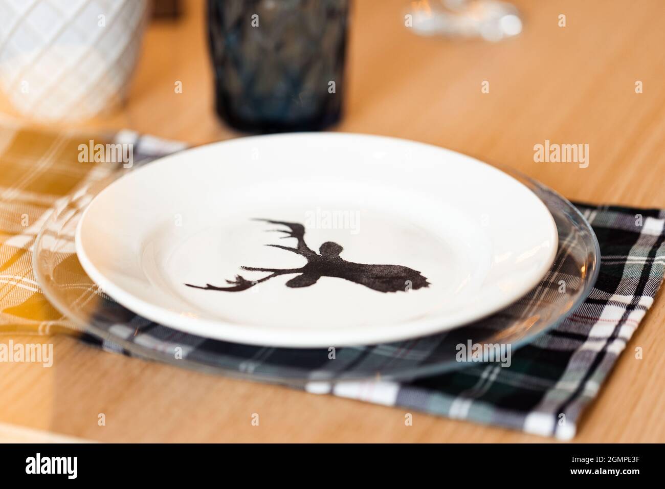 Christmas table setting with plate with deer silhouette Stock Photo - Alamy